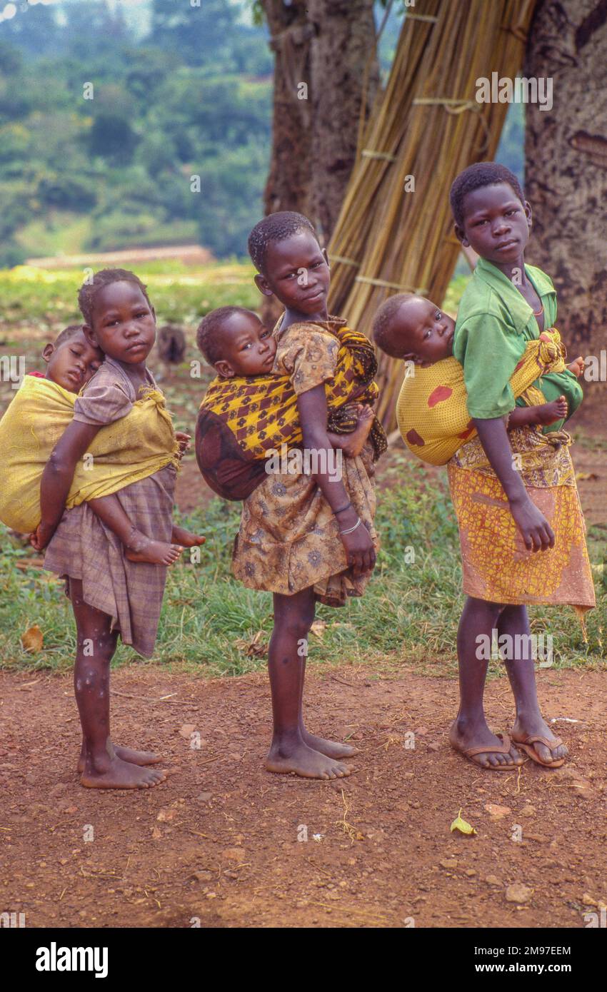 Uganda, Kampala; Children carrying babies on their backs Stock Photo ...
