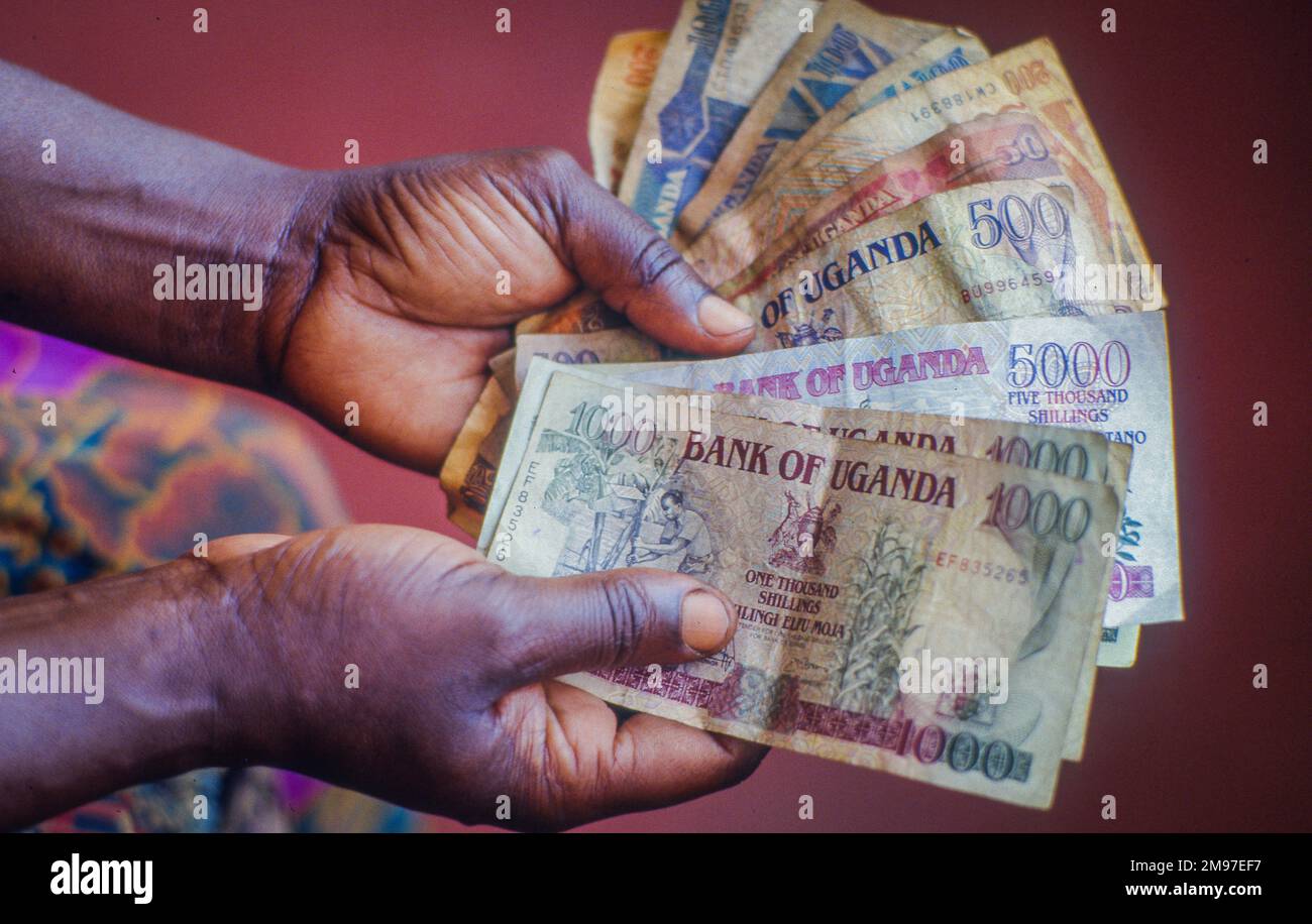 Uganda, Kampala, hands showing banknotes Stock Photo - Alamy