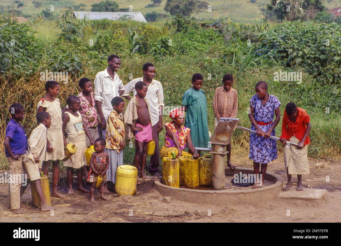 Uganda, villagers fetch water from the village pump Stock Photo - Alamy