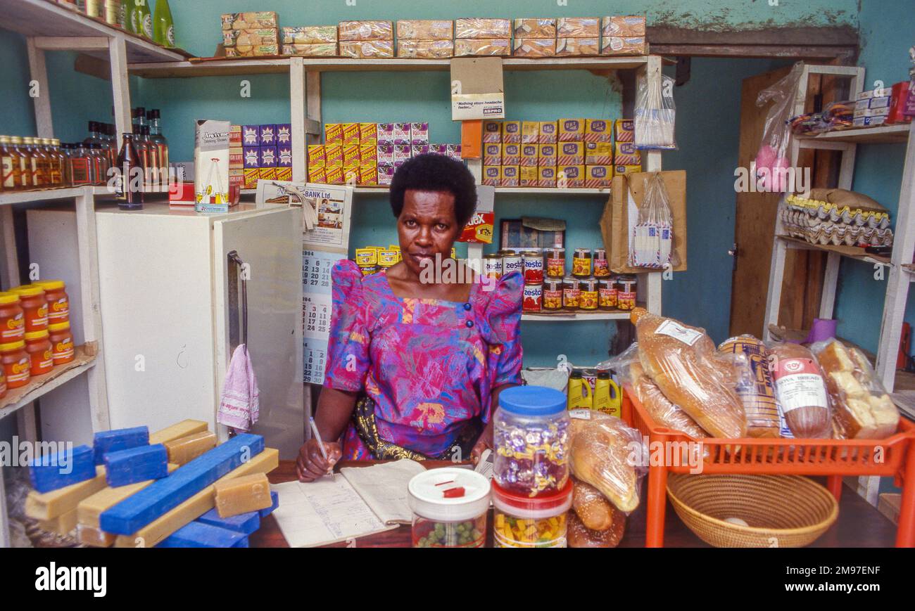 Uganda; woman keeping paperwork in grocery store Stock Photo - Alamy