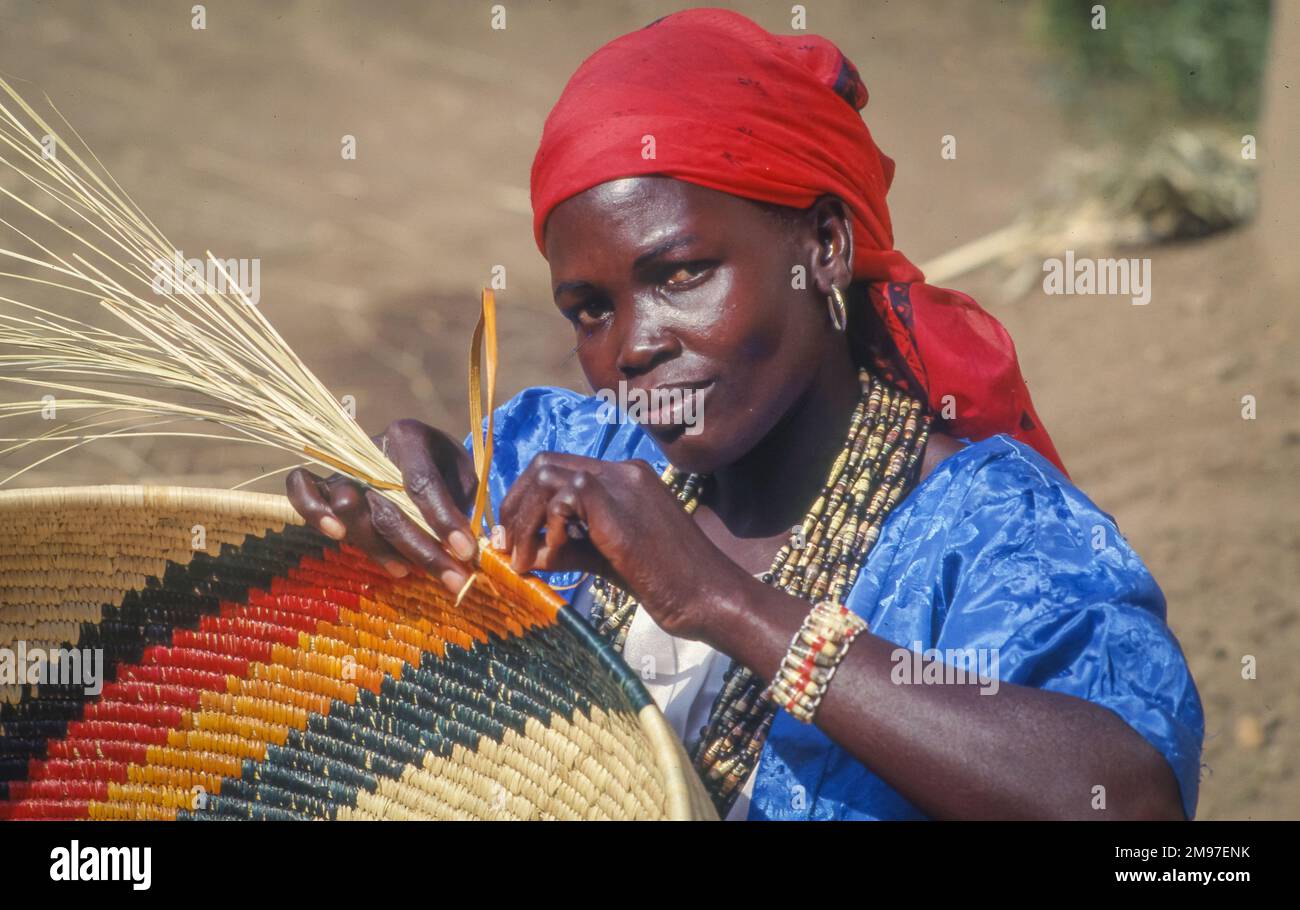 Uganda, Kampala; Portrait of a woman weaving traditional baskets Stock ...