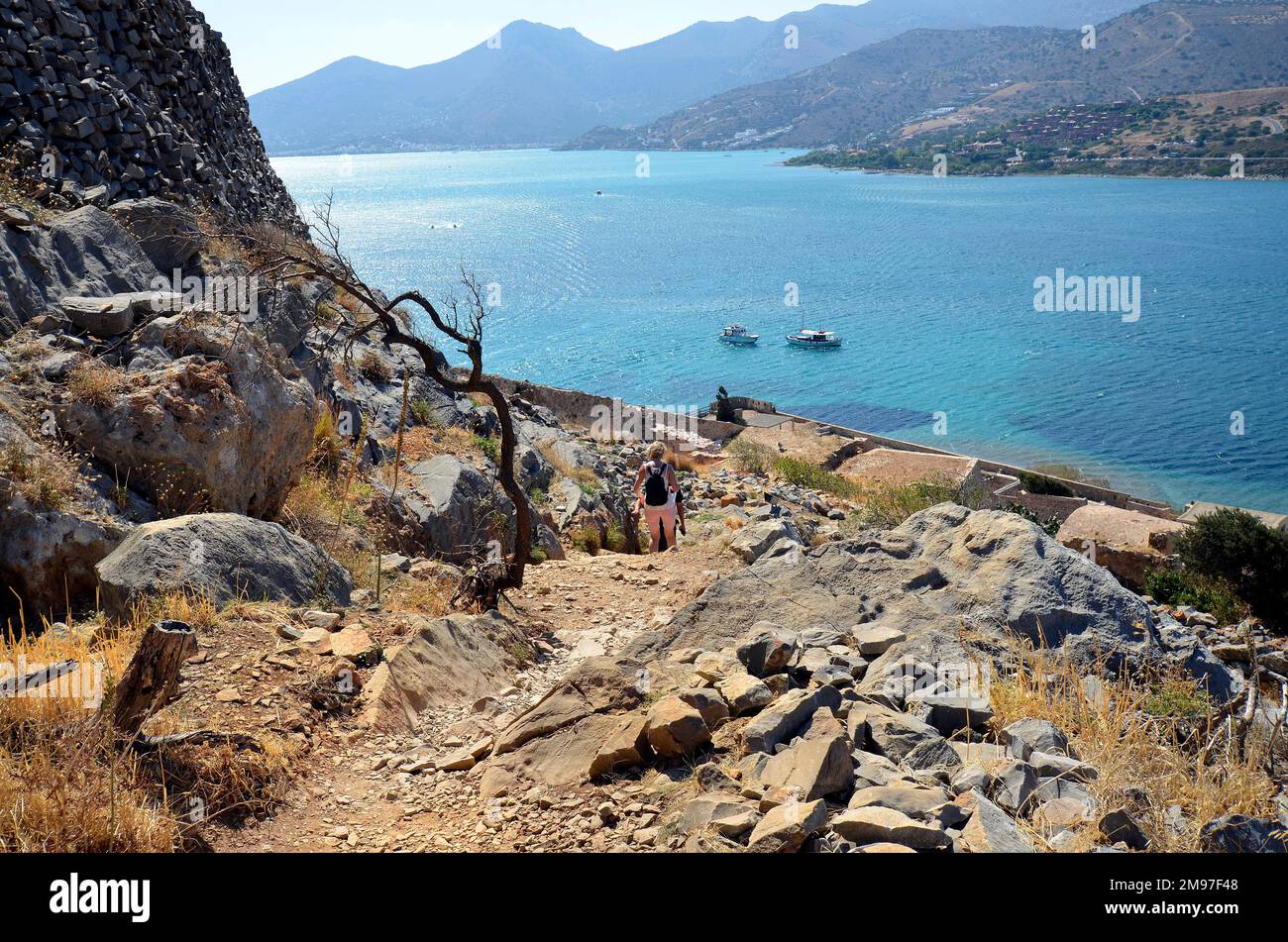 Greece, Crete, tourists on a difficult footpath visiting the old ...
