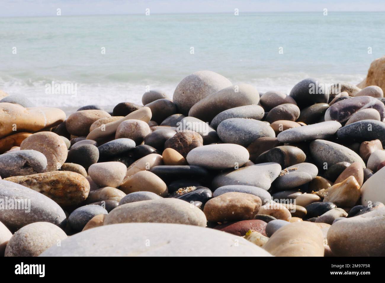 A close-up shot of colorful pebbles on the beach in sunlight Stock ...