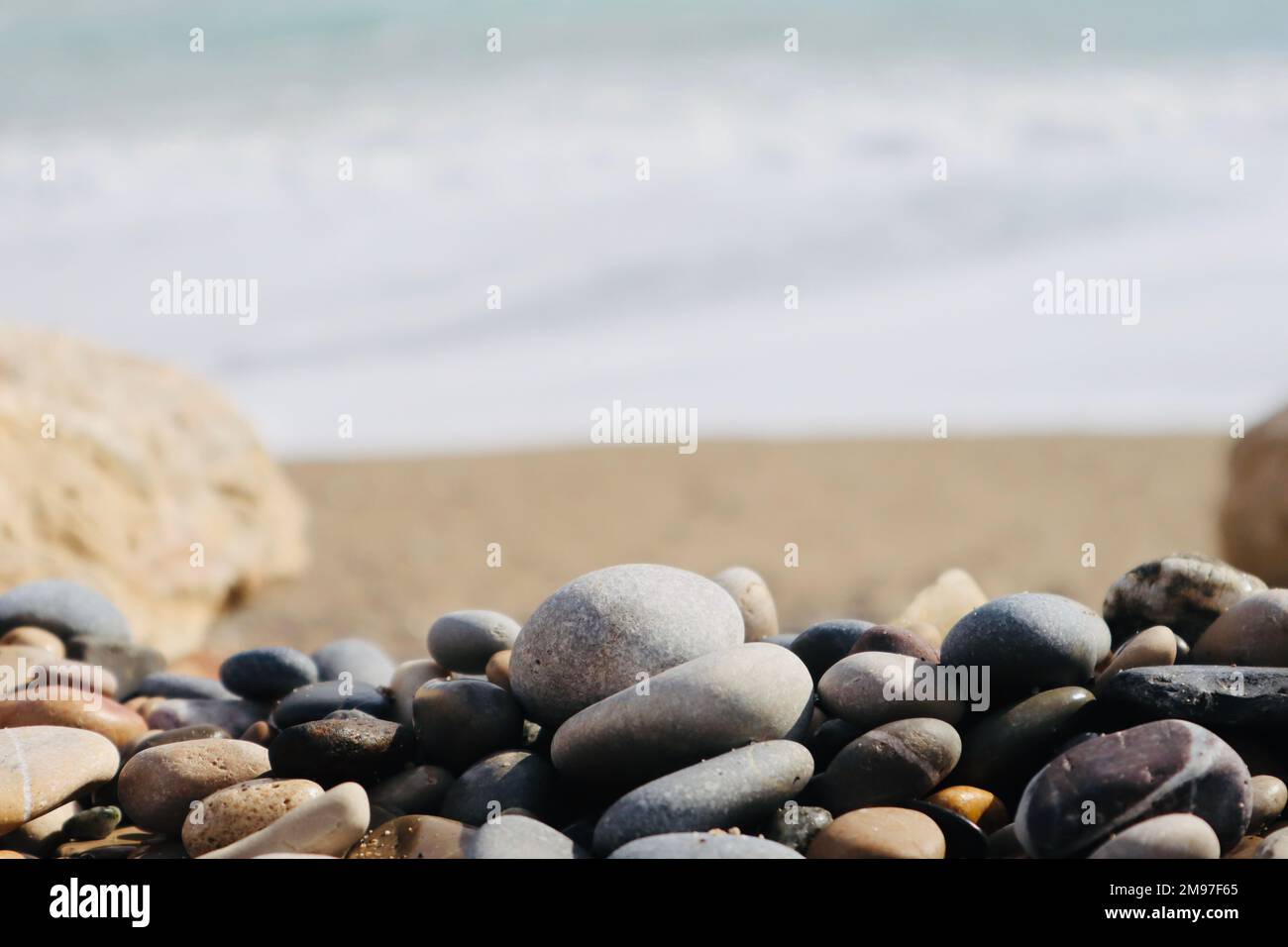 A close-up shot of colorful pebbles on the beach in sunlight Stock ...