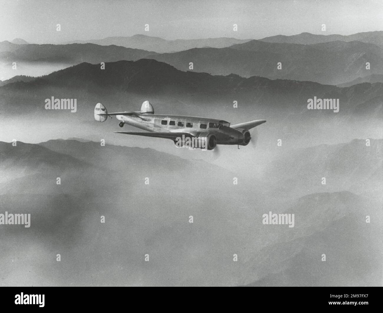 Lockheed L-10 Electra above misty hills Stock Photo - Alamy