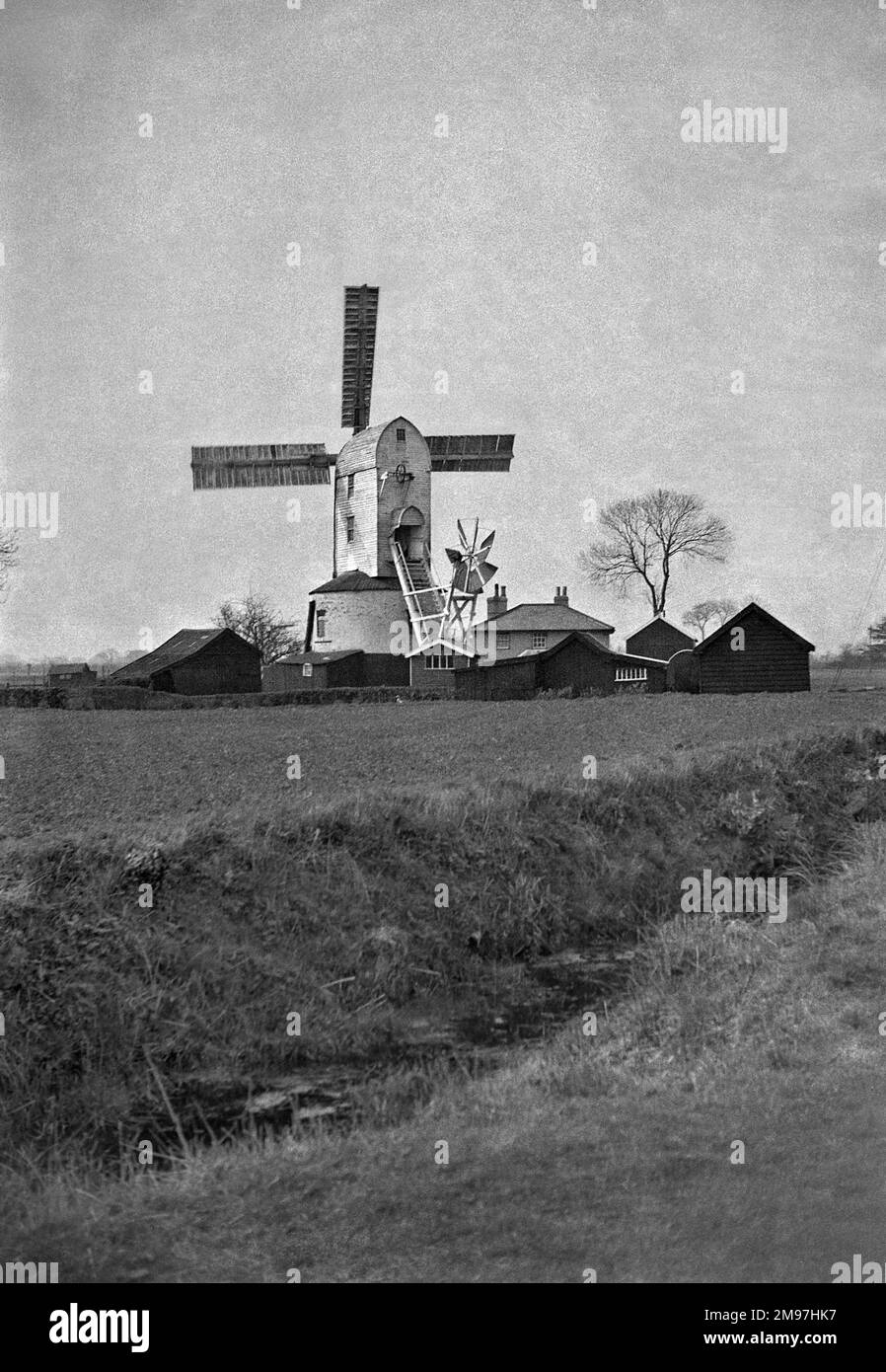 Windmill and farm buildings Stock Photo - Alamy