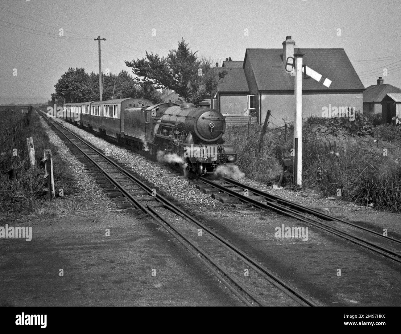 Steam engine and carriages on a railway track Stock Photo - Alamy