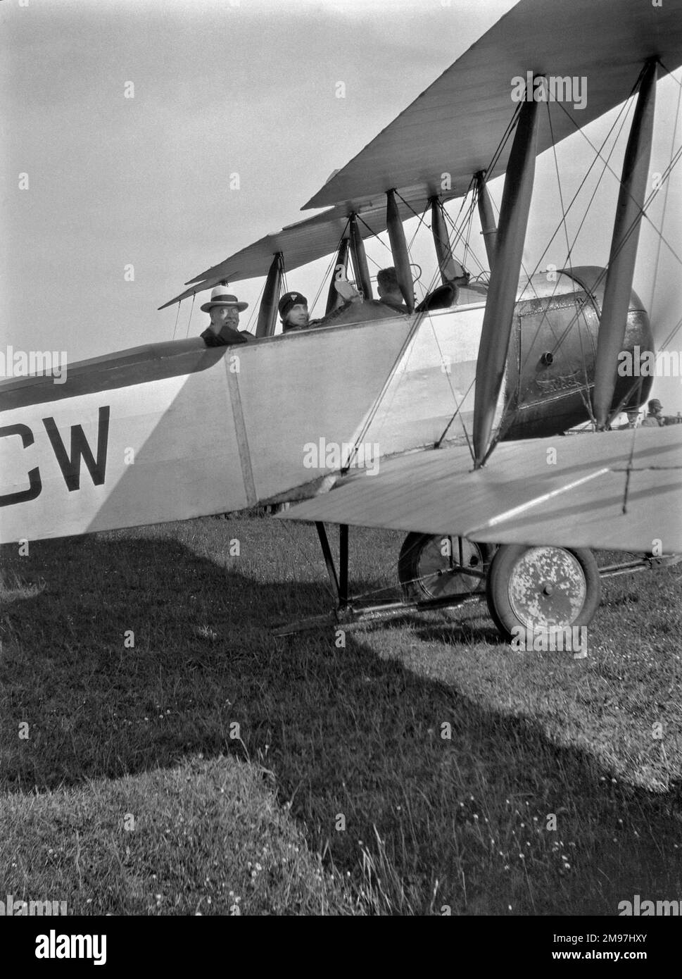 Three people in a biplane on an airfield Stock Photo - Alamy