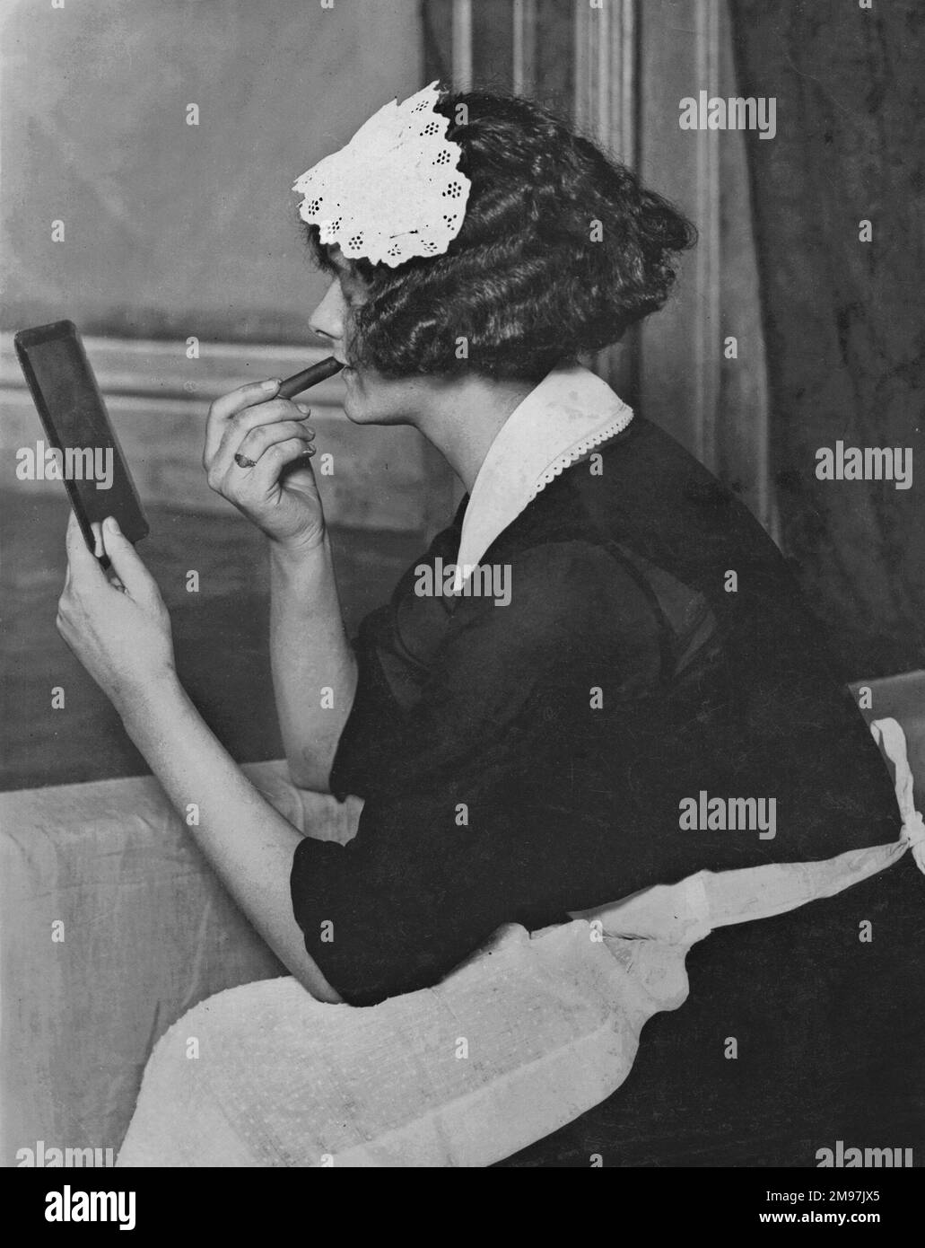 A maid applying lipstick Stock Photo - Alamy