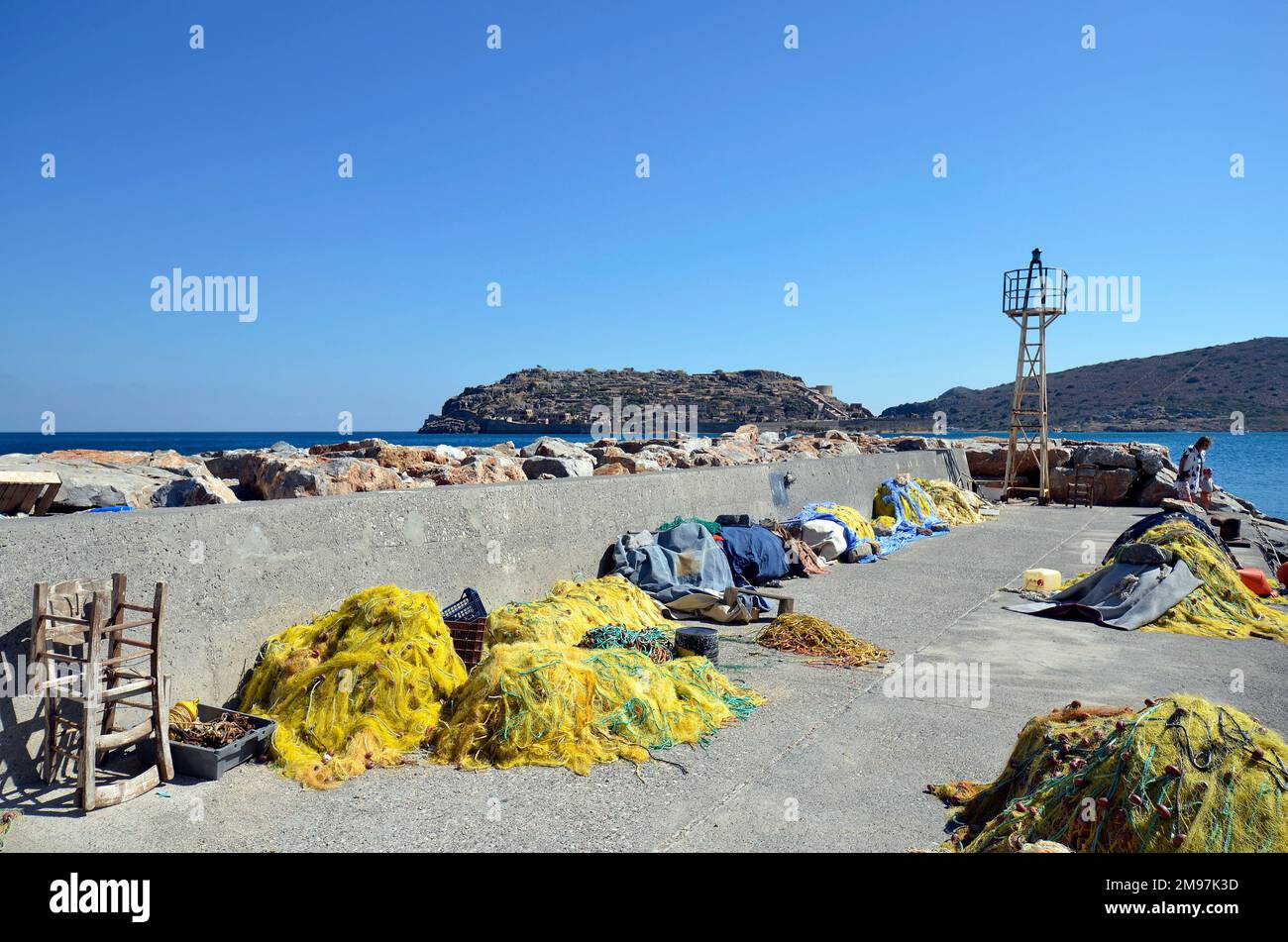 Greece, Crete, mole with fishing nets and boats in the port of Plaka ...