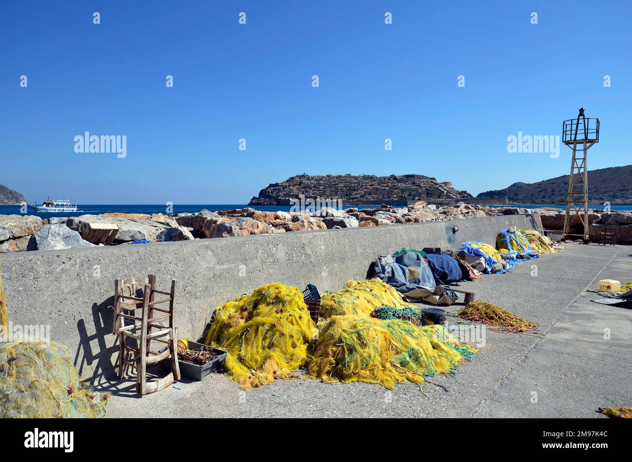 Greece, Crete, mole with fishing nets and boats in the port of Plaka ...