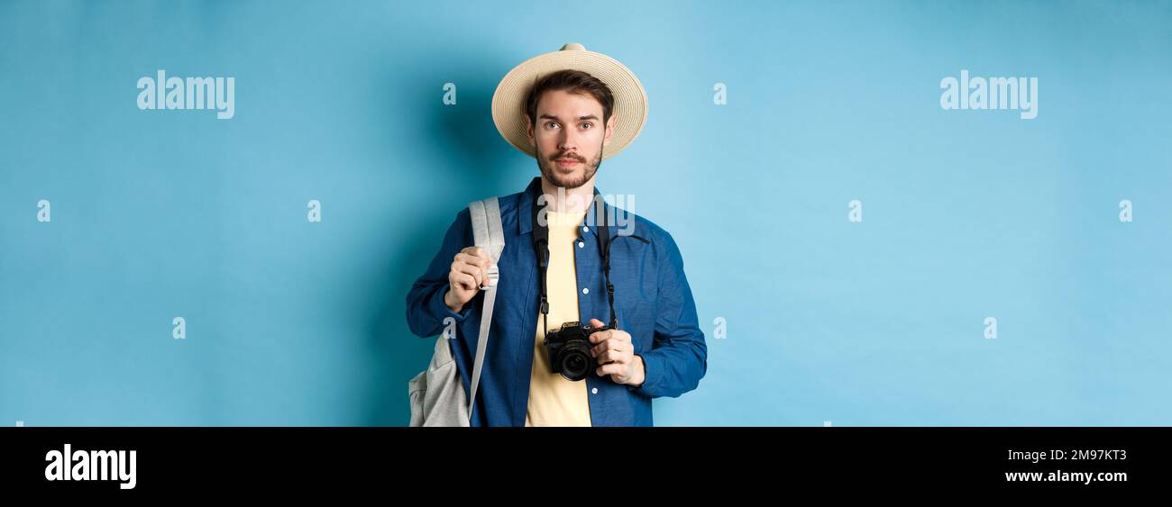 Handsome young tourist in summer hat, backpacking and travelling ...