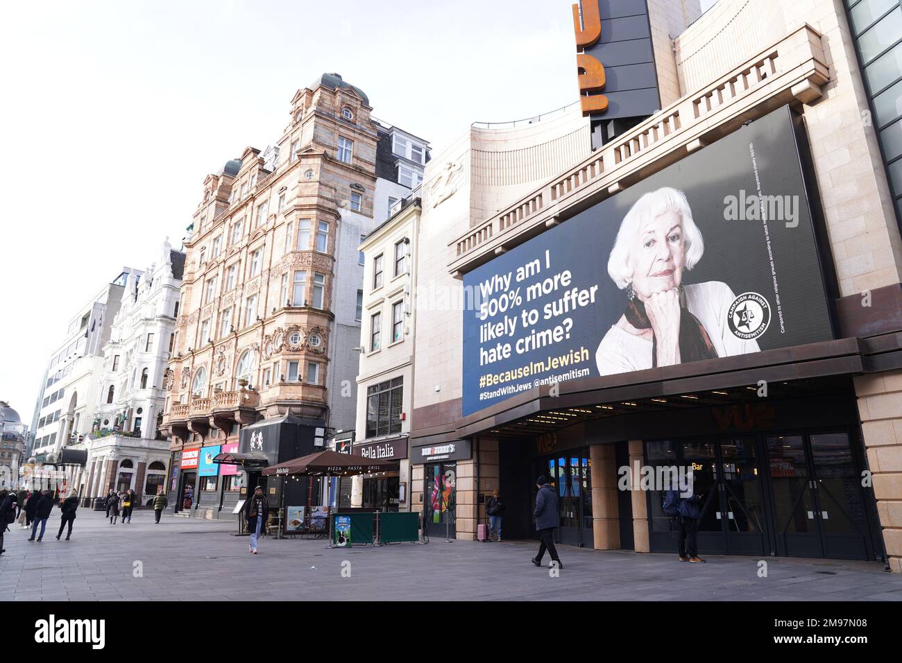 People walk past a billboard in Leicester Square, London, which is part ...