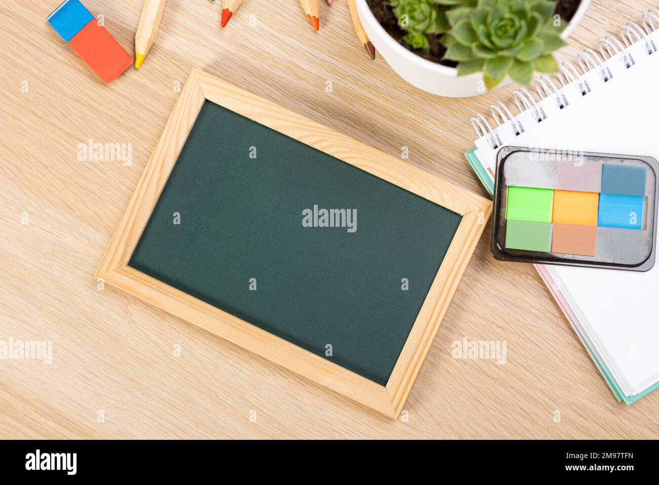 School chalkboard mockup on work desk. Composition of a student's desk ...