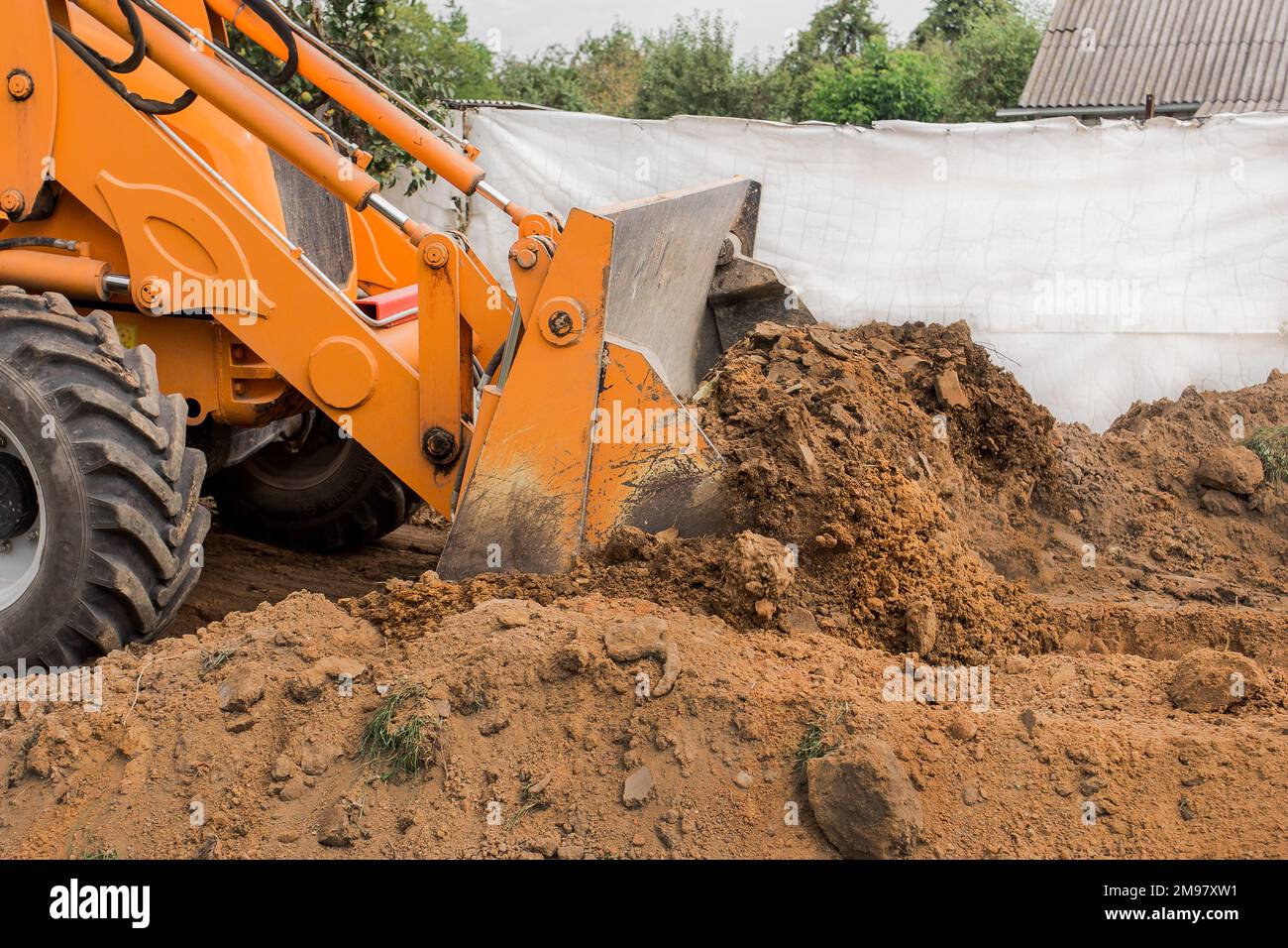 Tractor bucket level soil in hi-res stock photography and images - Alamy