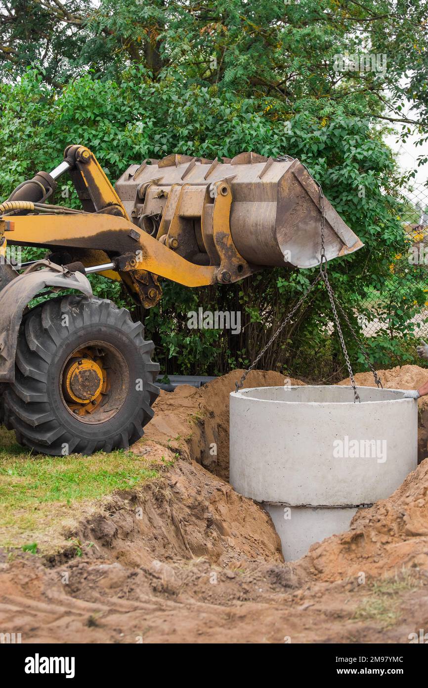 Hydraulic piston system of the excavator with a bucket, lowering into ...
