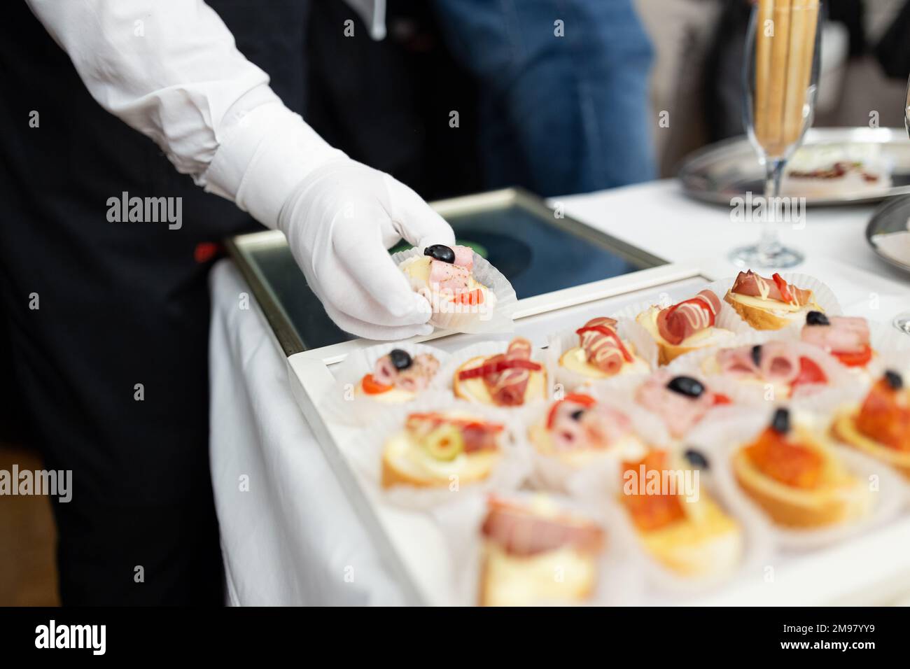 Waiters serving buffet canape food at the table on celebration event ...