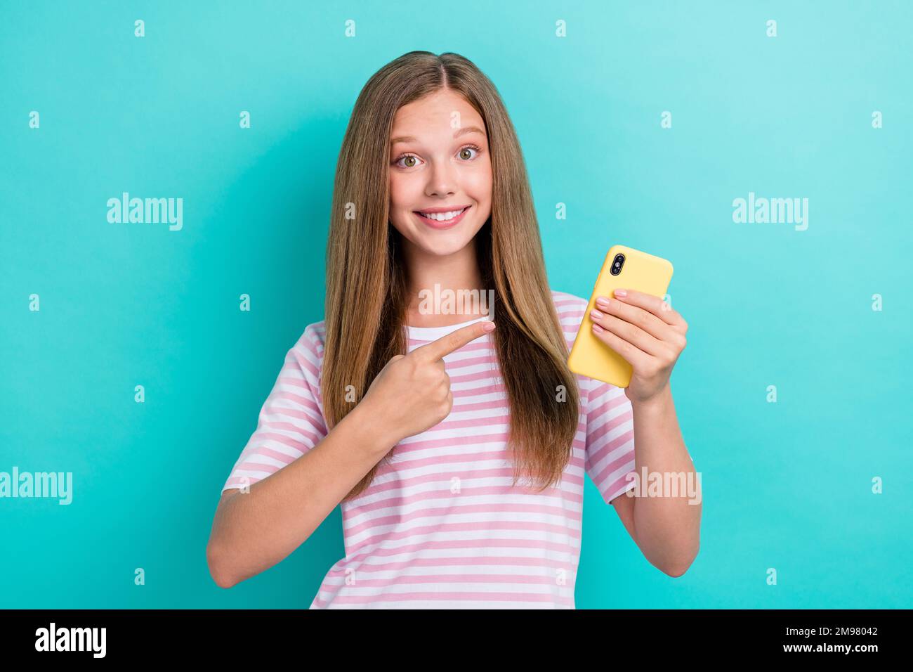 Photo of cute schoolgirl toothy smile indicate finger hand hold ...