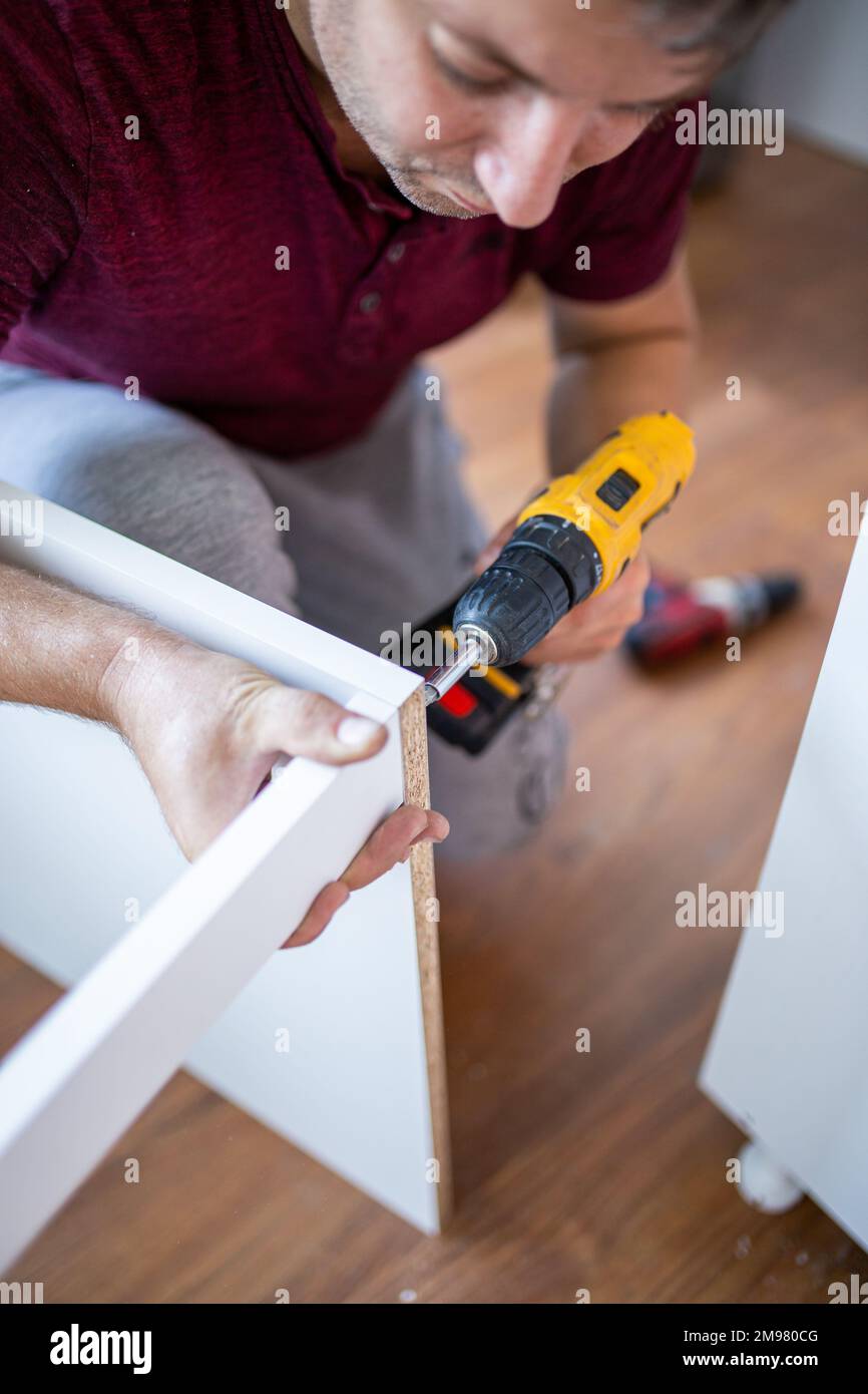 Furniture Installation Man Using Electric Drill Assembling And Fixing
