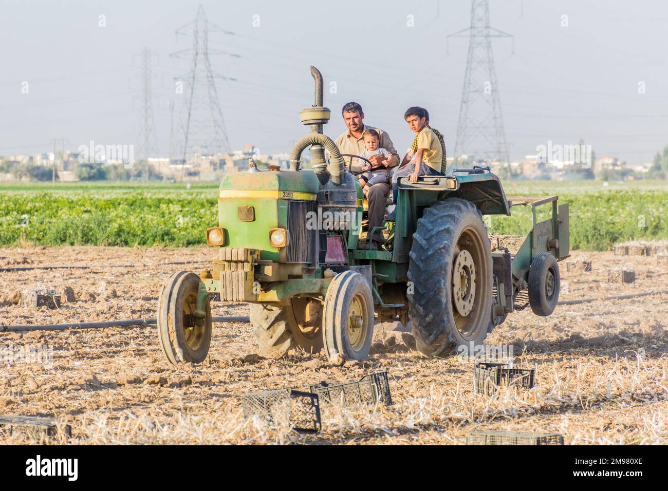 BAHAR, IRAN - JULY 13, 2019: Farmer family on their tractor near Bahar ...