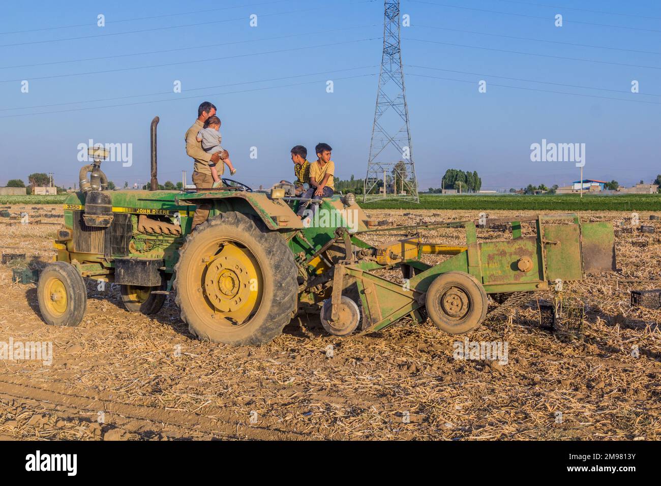 BAHAR, IRAN - JULY 13, 2019: Farmer family on their tractor near Bahar ...