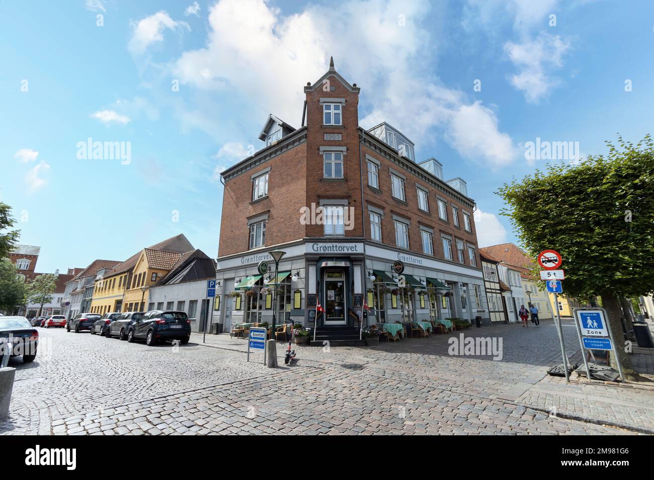 The cloudy blue sky over the street and buildings in Odense, Denmark Stock Photo - Alamy