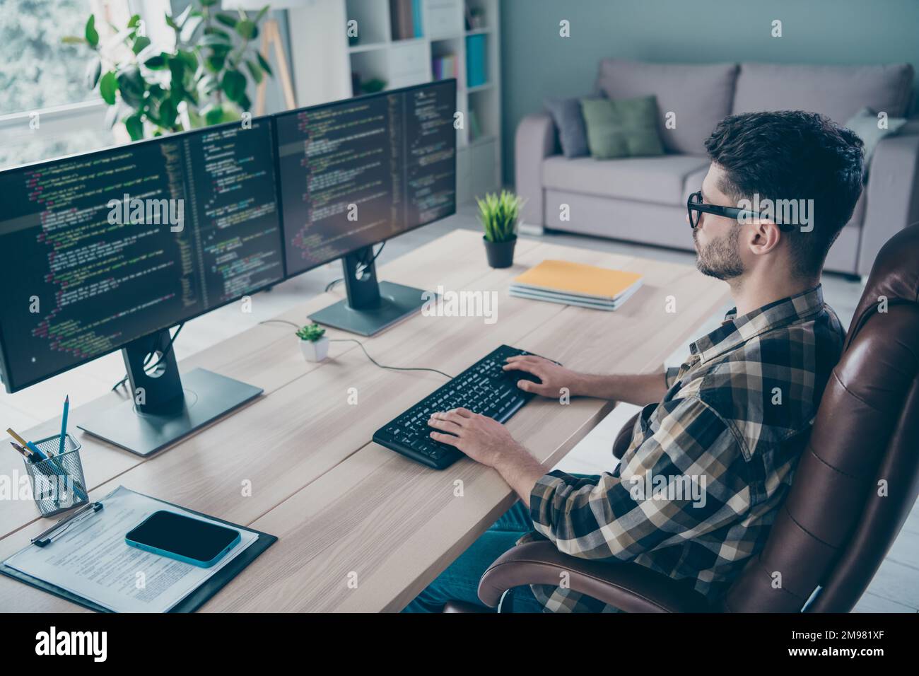 Photo of cool serious freelancer wear eyeglasses creating new it ...