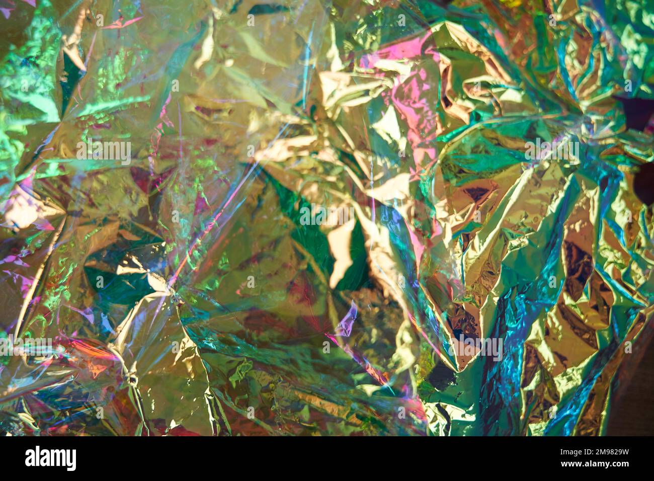 Crumpled iridescent foil with a real texture. Unfocused holographic ...