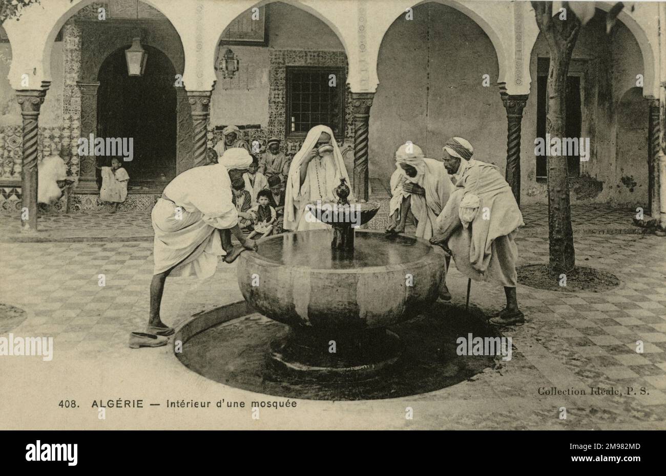 Interior of a Mosque, Algeria. Four men gather around an ablution ...