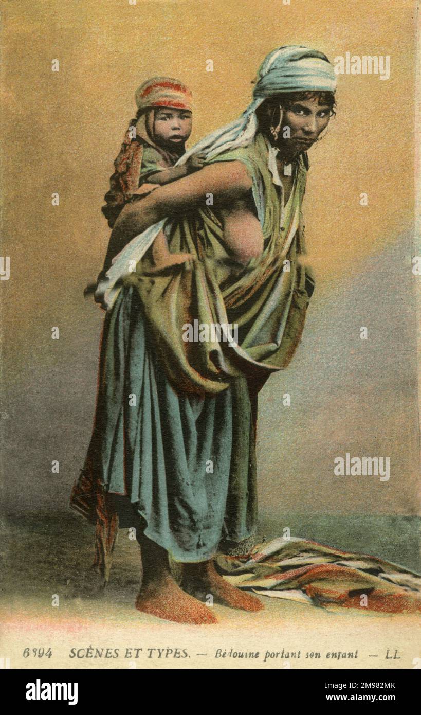 Bedouin woman carrying her child on her back. Both wear traditional ...