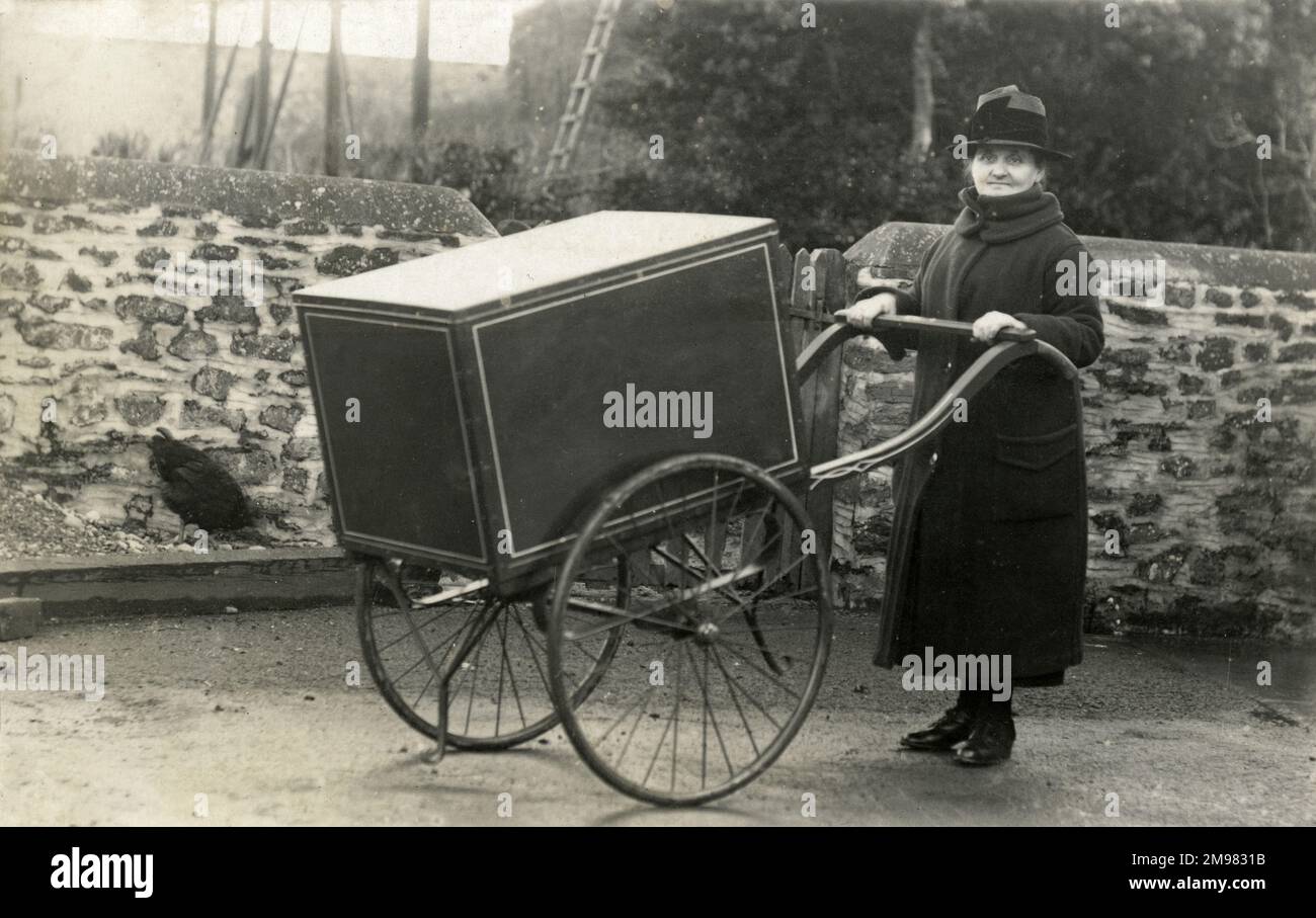 What's in the Box? A woman pushing a box on wheels Stock Photo - Alamy