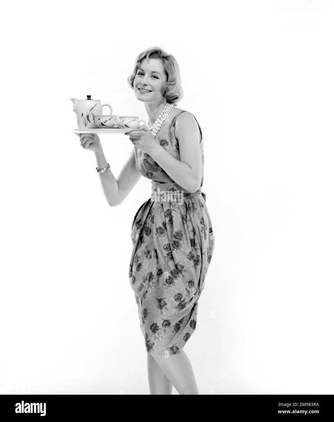 Advertisement for Nescafe -- female model (Sandra Paul) with tray Stock ...