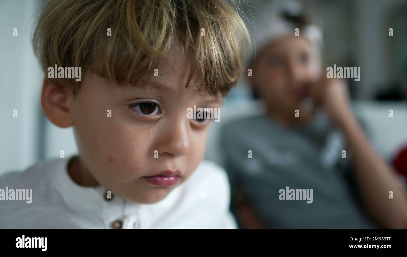 Children watching movie staring at screen sitting at couch. Kids ...