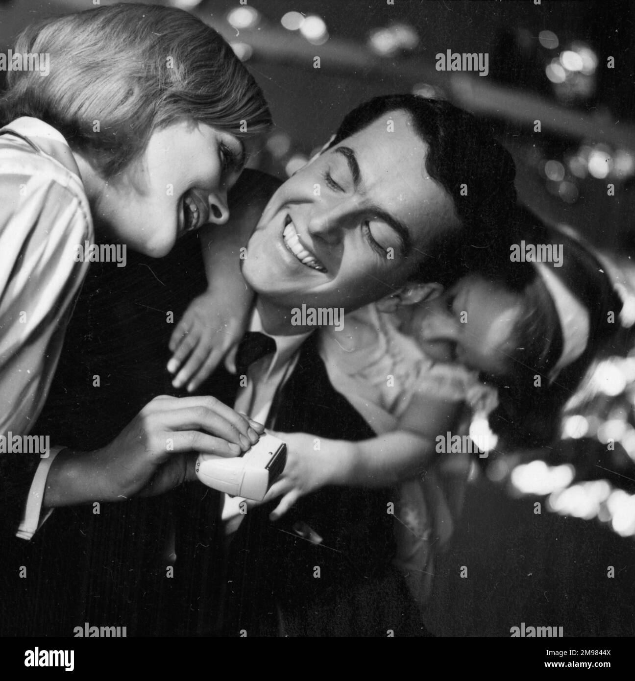 Advertisement for Remington shavers -- three models posing as a happy ...