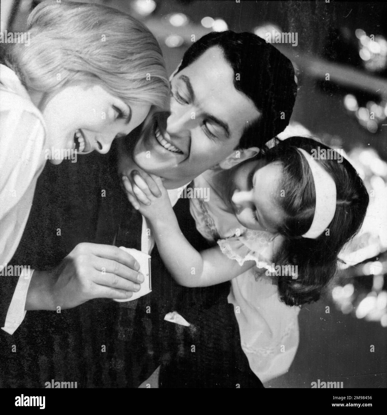 Advertisement for Remington shavers -- three models posing as a happy ...