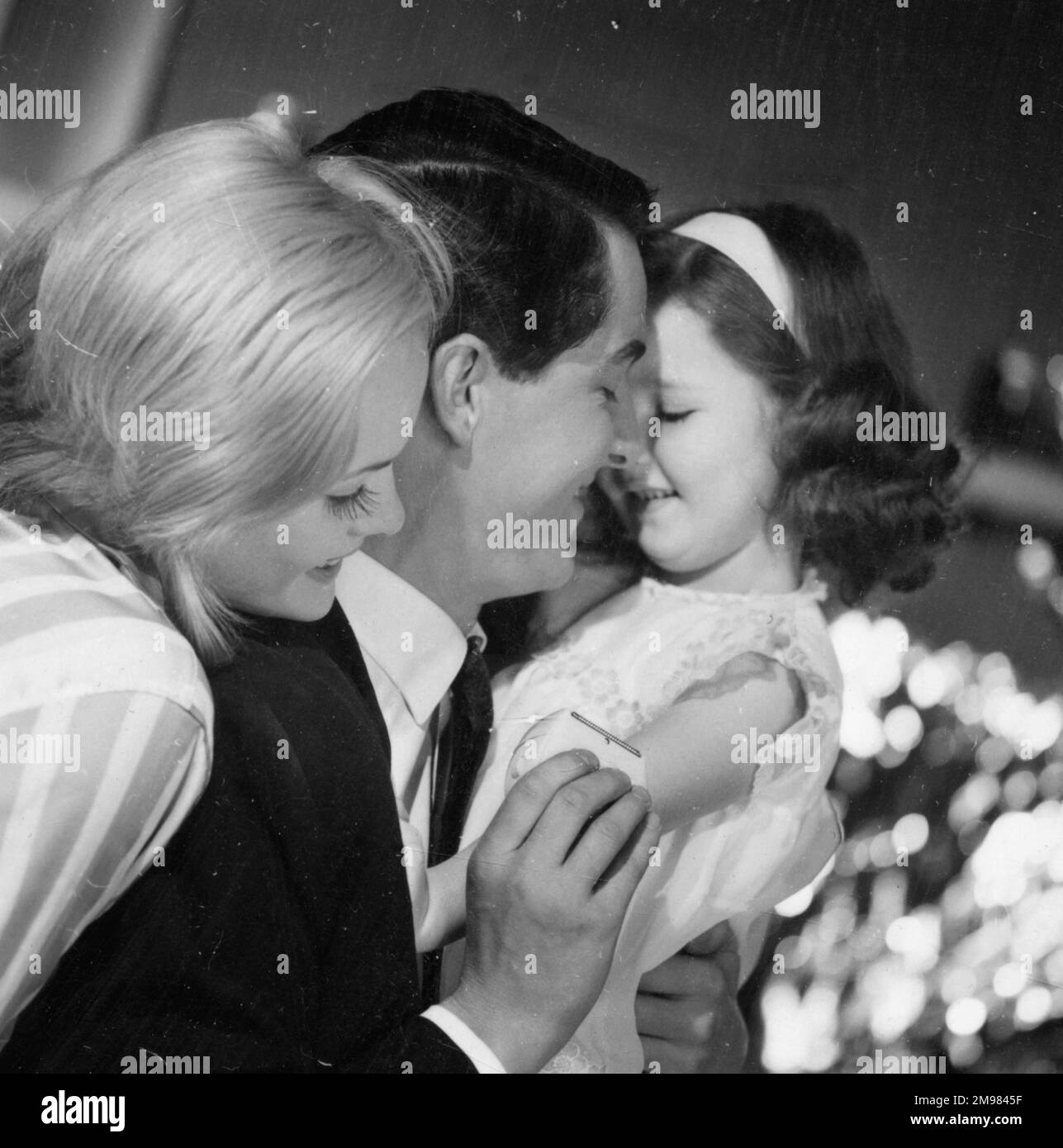 Advertisement for Remington shavers -- three models posing as a happy ...