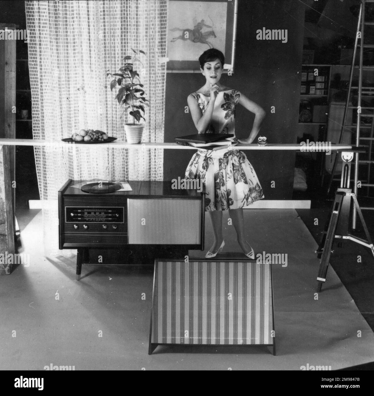 Advertisement for Expanded Fittings furniture -- female model ...