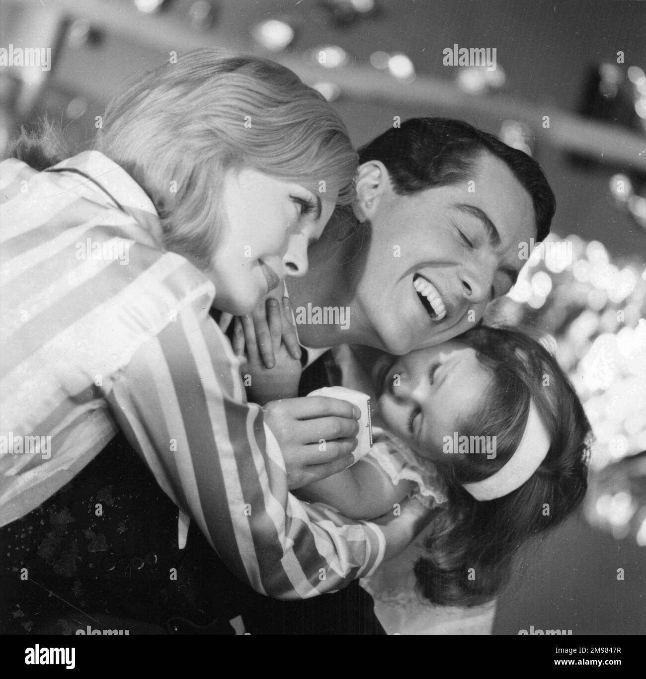 Advertisement for Remington shavers -- three models posing as a happy ...