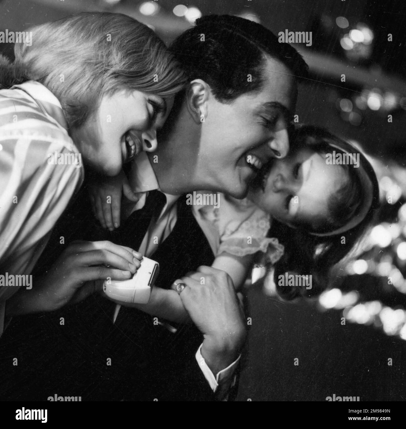 Advertisement for Remington shavers -- three models posing as a happy ...