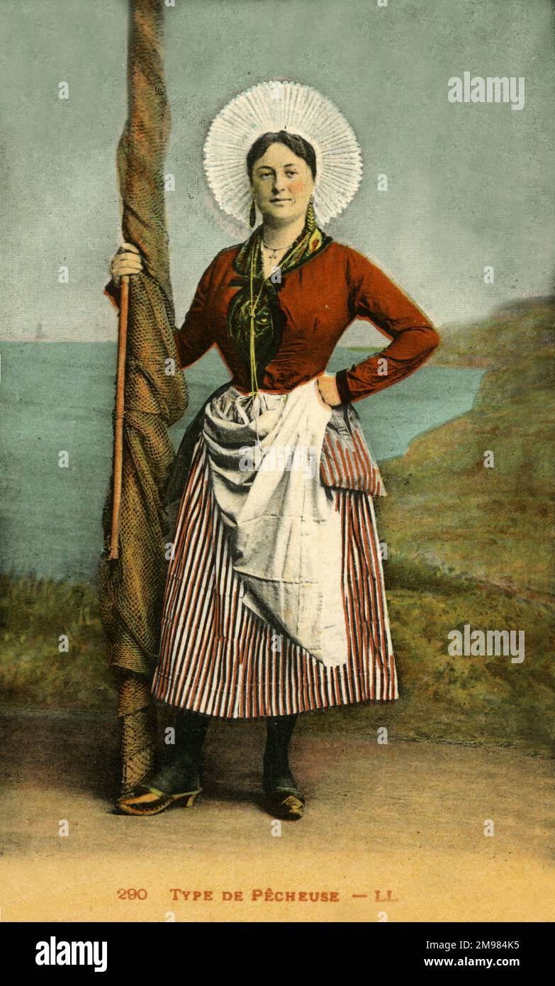 French fisherwoman in traditional costume, holding a large rolled up ...