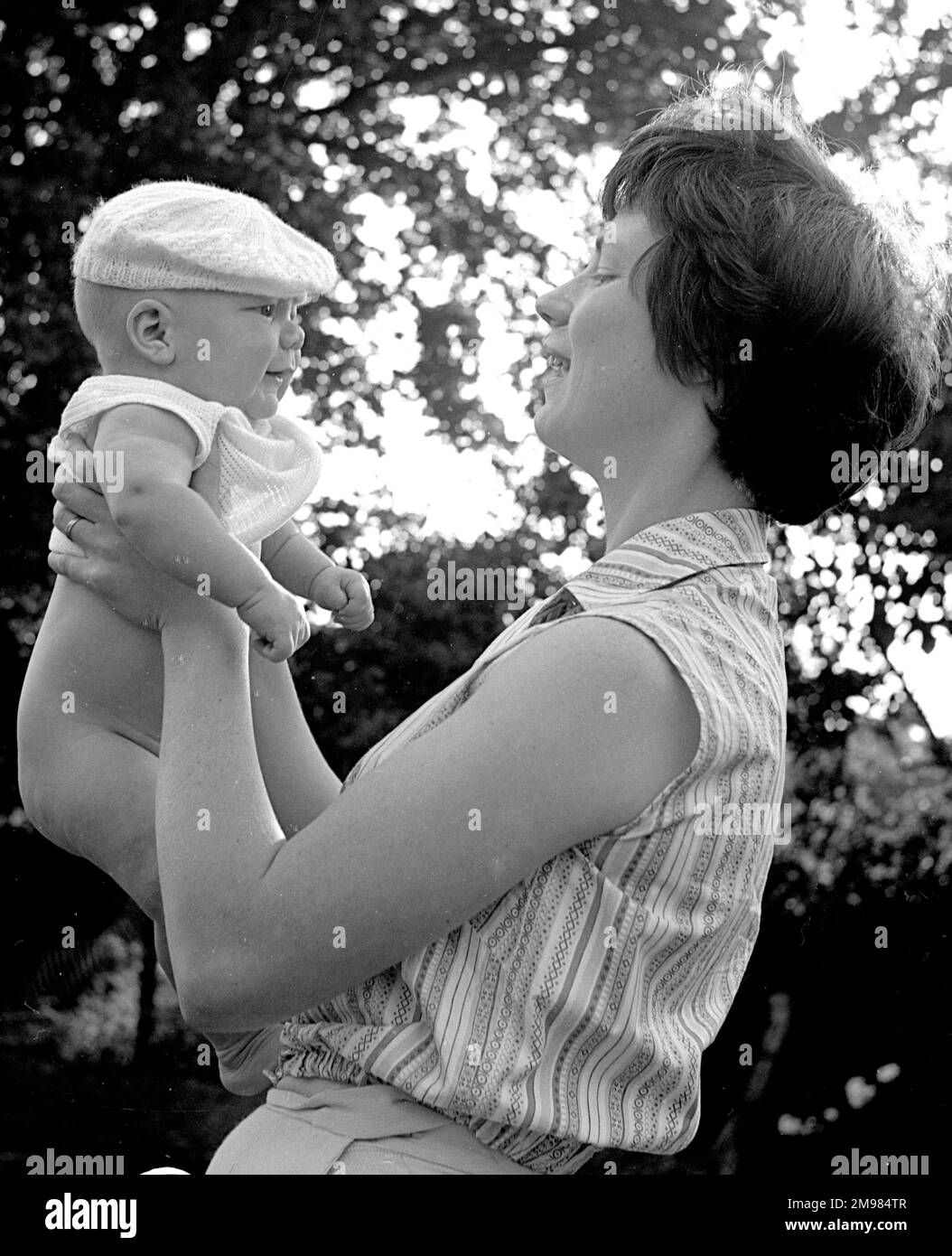 A young mother holding her cheeky baby son Stock Photo - Alamy