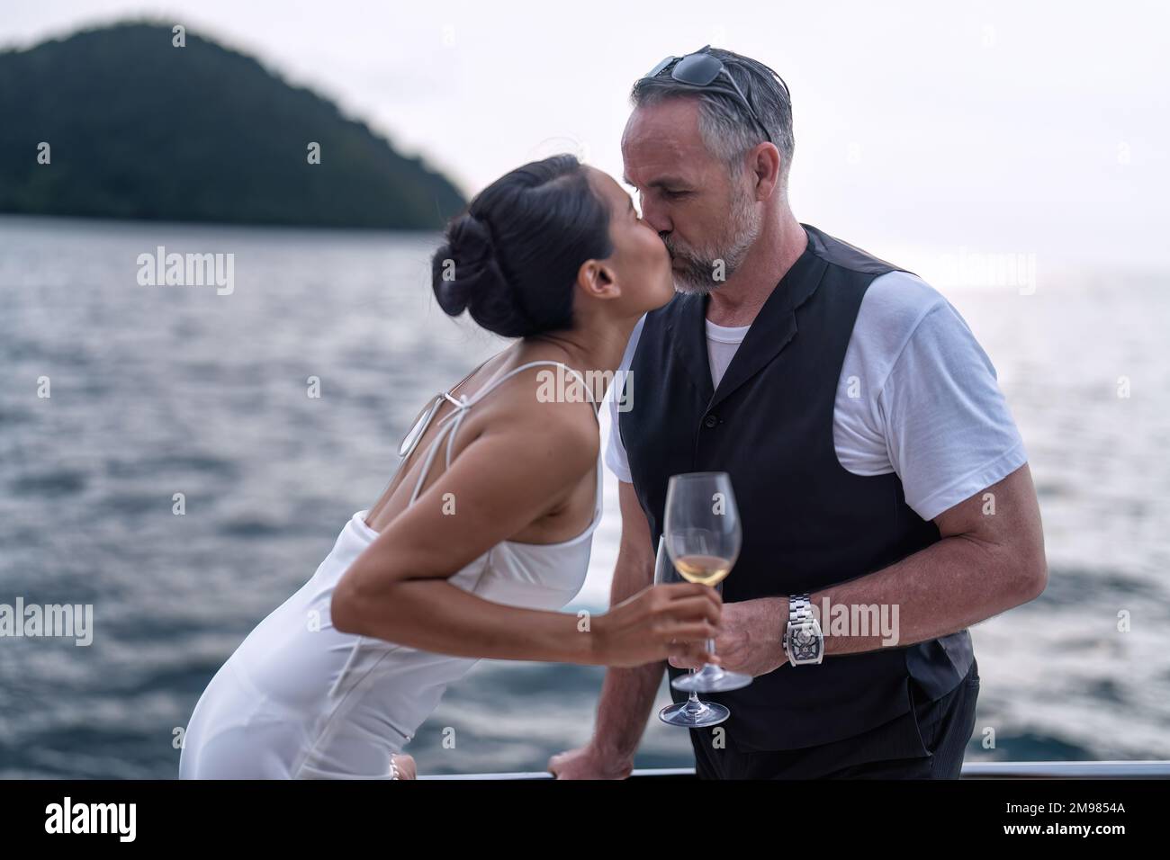 Romantic couple in love have fun sailing in the sea standing on yacht ...