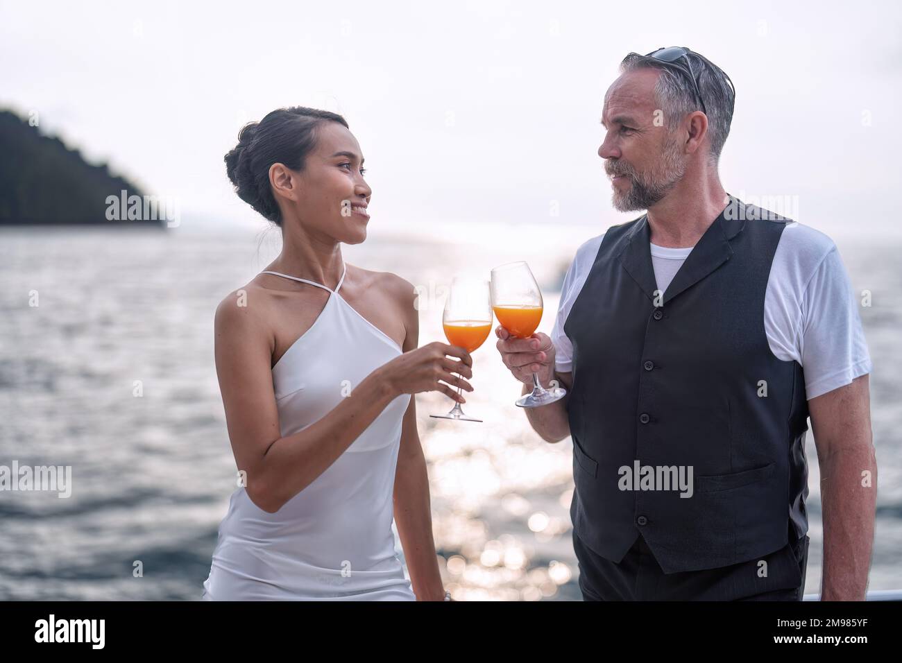 Romantic couple in love have fun sailing in the sea standing on yacht ...