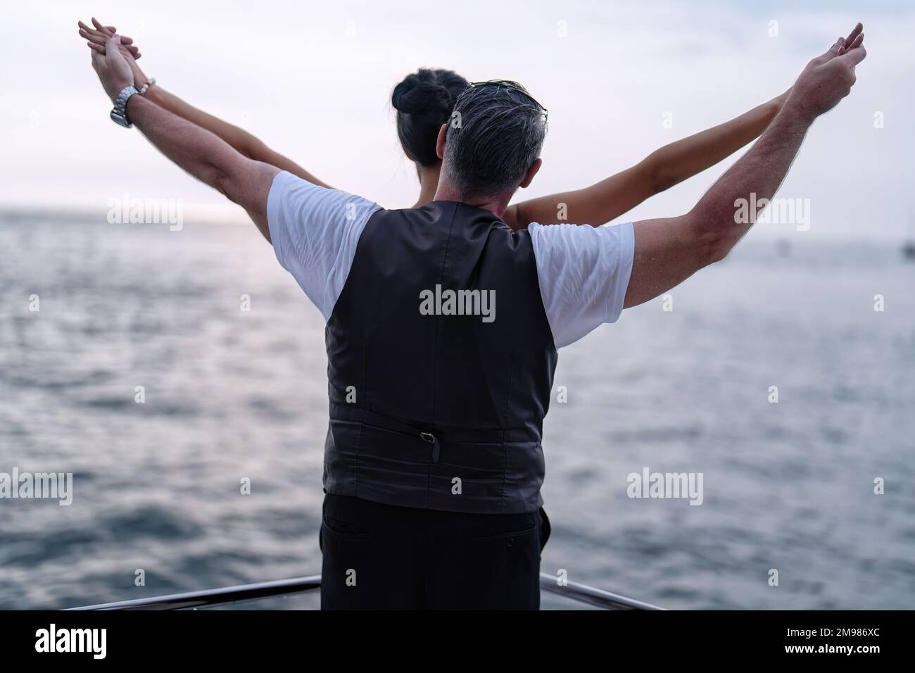 Romantic couple in love have fun sailing in the sea standing on yacht ...