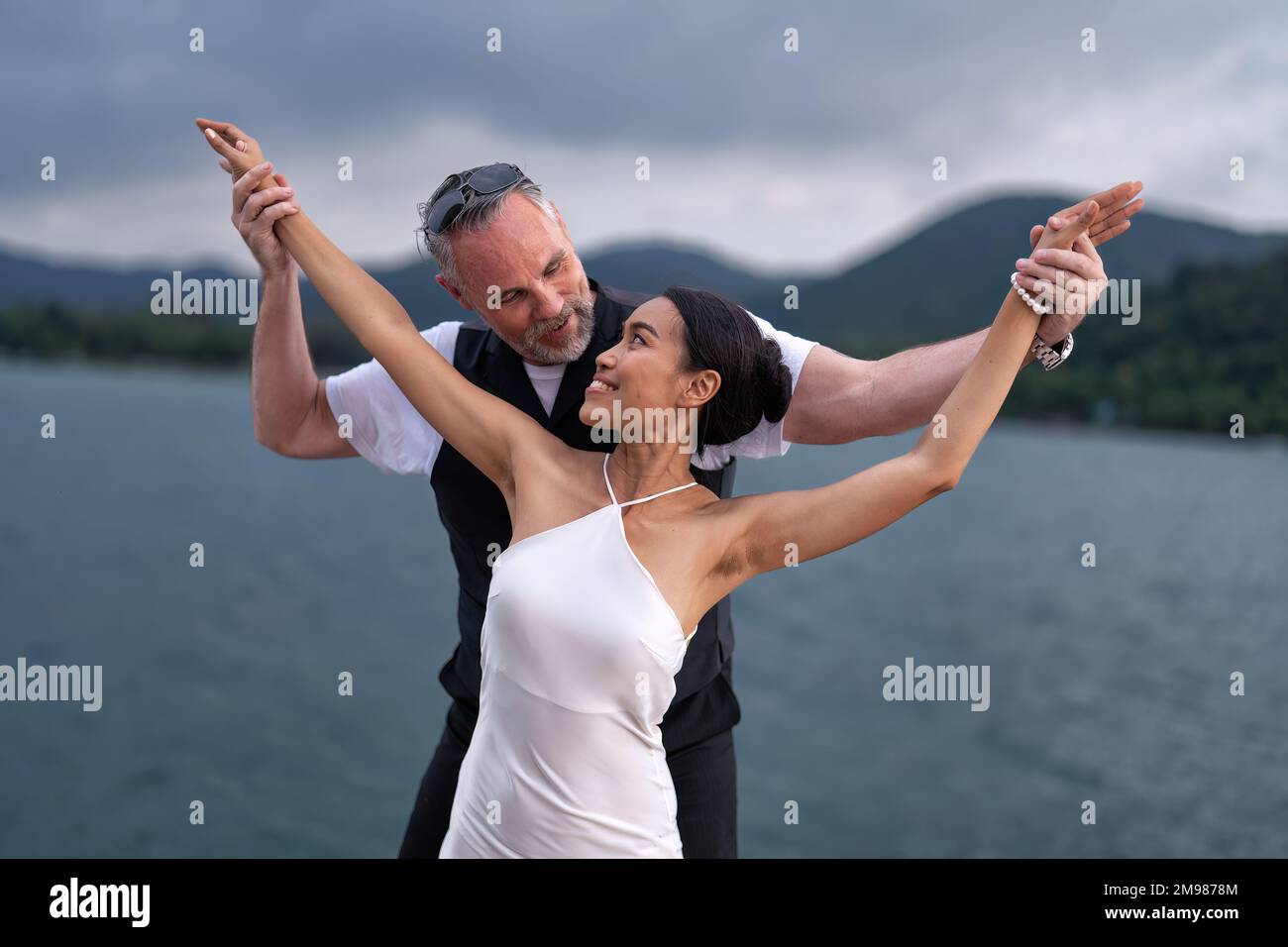 Romantic couple in love have fun sailing in the sea standing on yacht ...