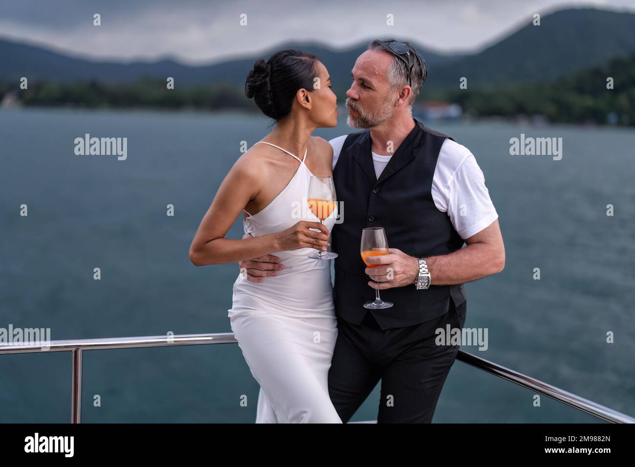 Romantic couple in love have fun sailing in the sea standing on yacht ...