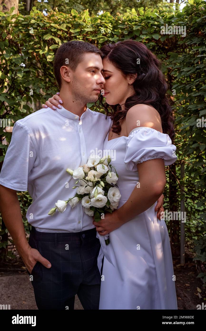 Sad Ukrainian bride hugs a young husband who is sent to war. A sad love ...