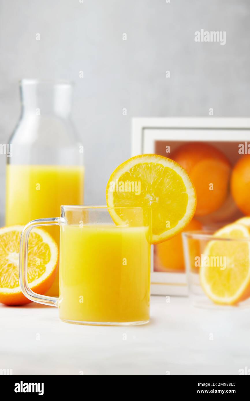 Bottle and glass of freshly squeezed orange juice with fresh oranges ...