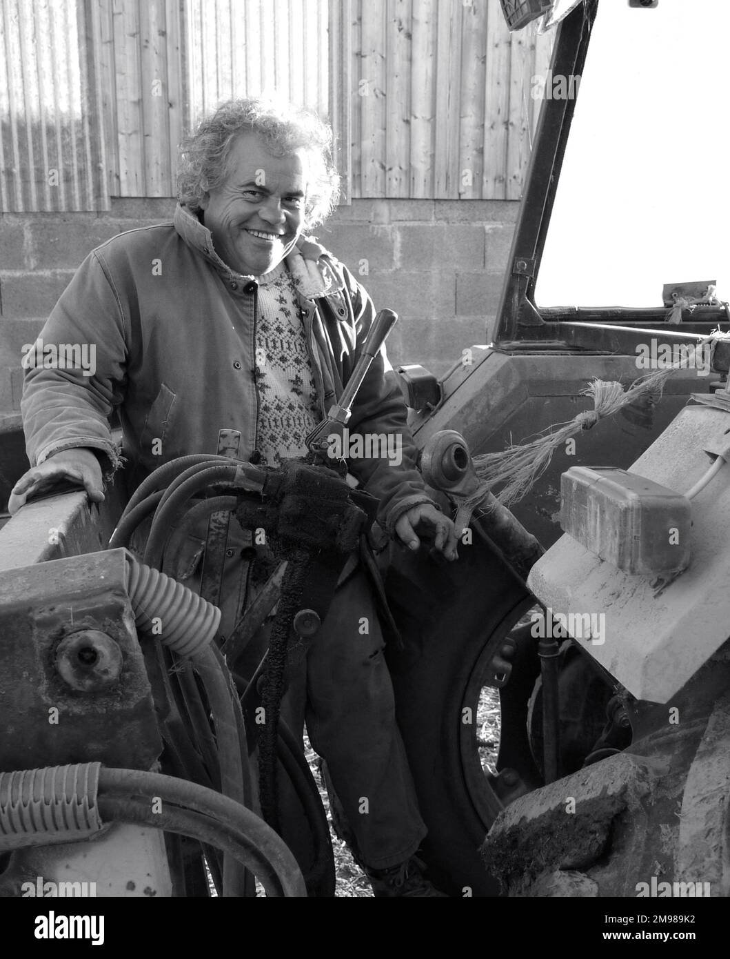 Happy French farmer with his tractor Stock Photo - Alamy