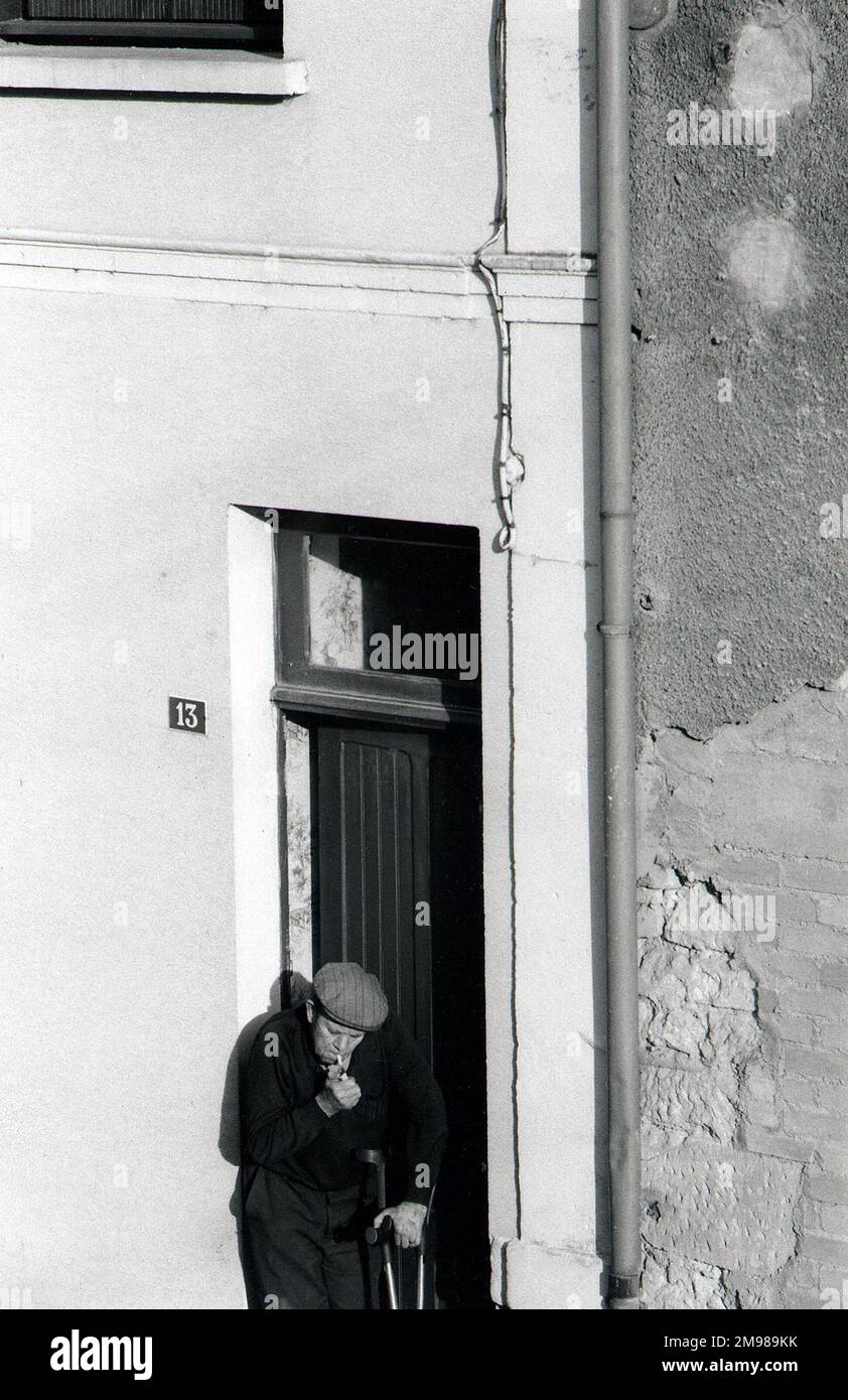 Man lighting a morning cigarette in a French street Stock Photo - Alamy